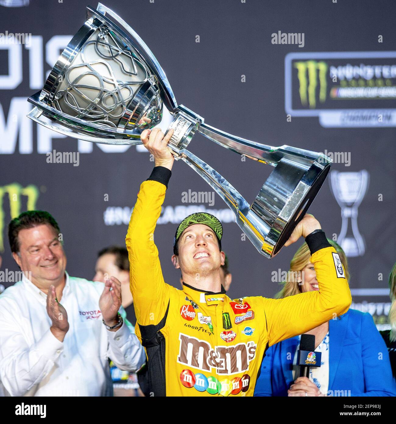 Kyle Busch (18) lifts the trophy after winning the Homestead-Miami ...