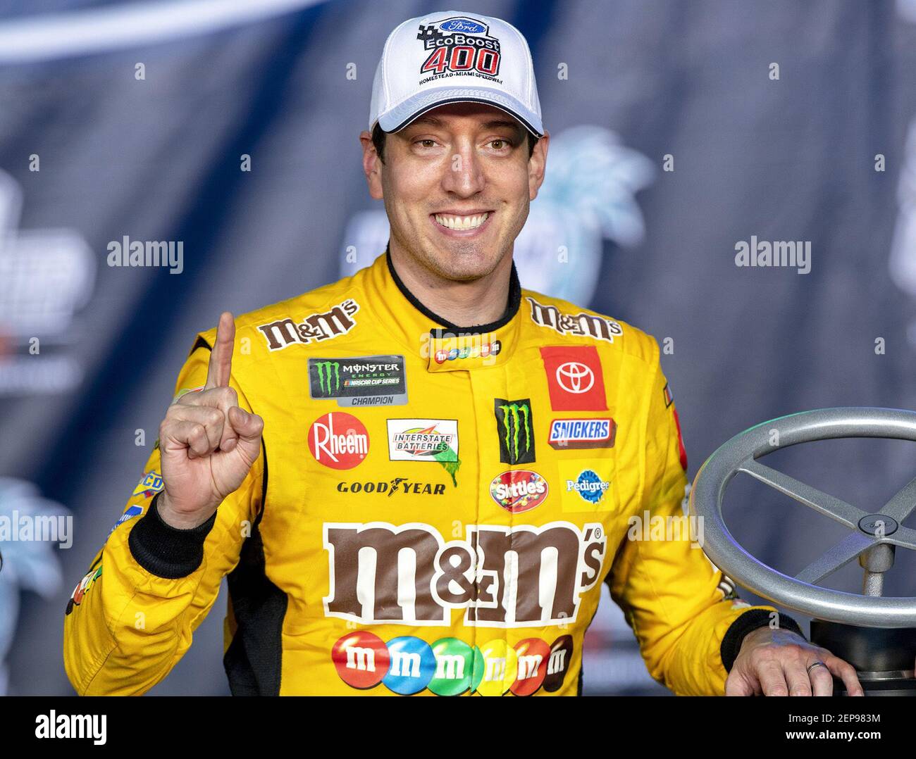 Kyle Busch (18) poses next to the race trophy after winning the ...