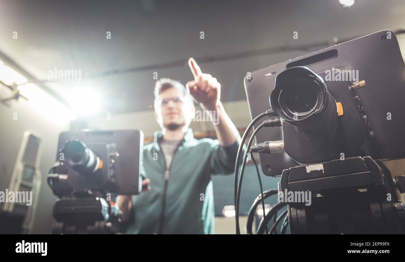 Male cameraman is operating a film camera in a television recording ...