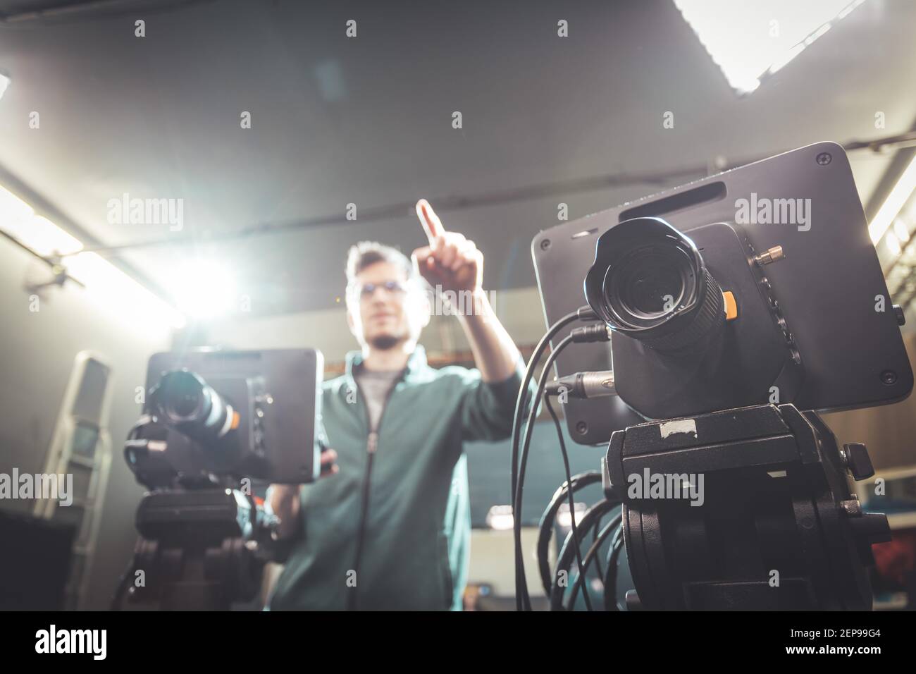 Male cameraman is operating a film camera in a television recording ...