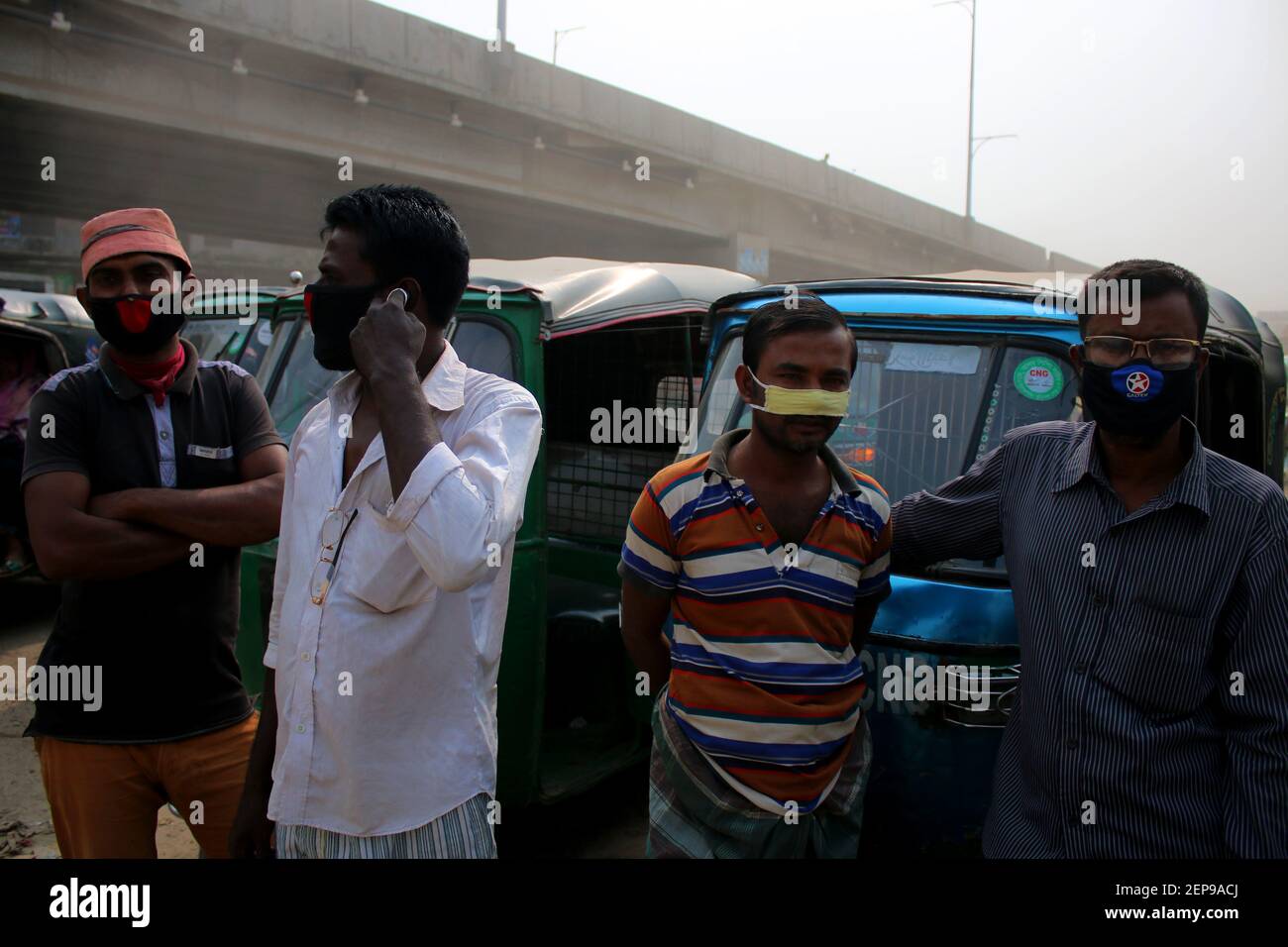 Drivers wearing face masks while waiting for passengers at a CNG ...