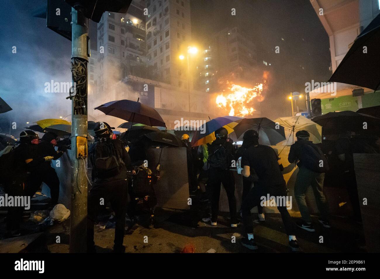 Protesters take cover behind their umbrellas during the demonstration ...