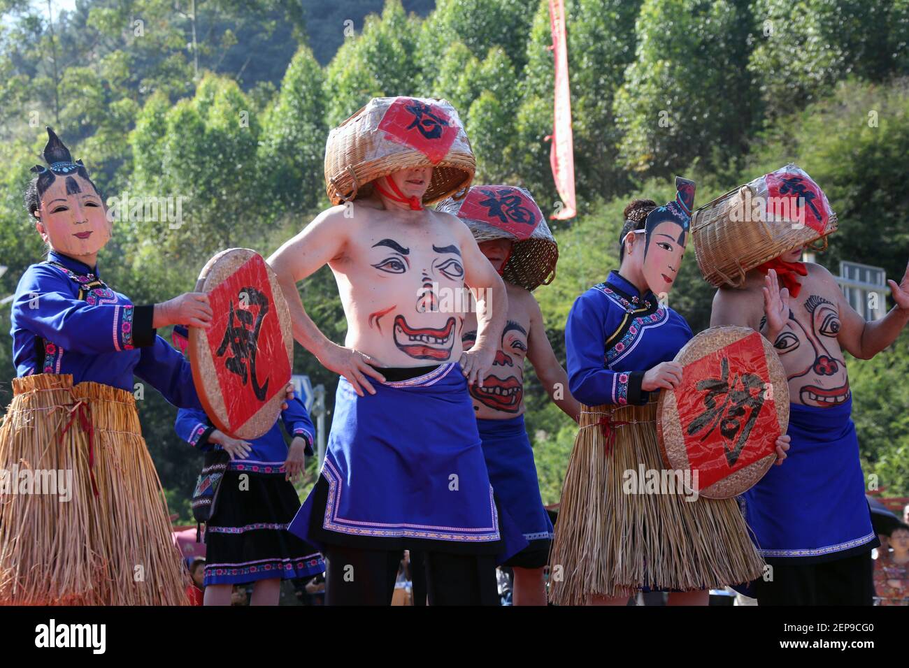 The Zhuang people are dancing traditional dwarf dance to celebrate the harvest in Jingxi,Guangxi ...