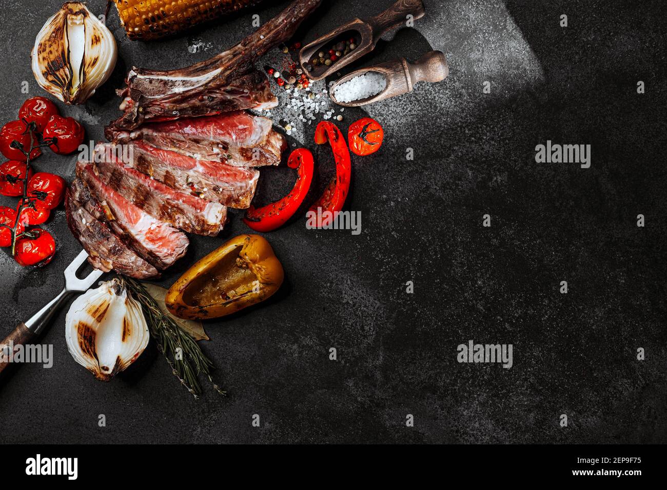 fresh grilled tomahawk steak with vegetables Stock Photo - Alamy