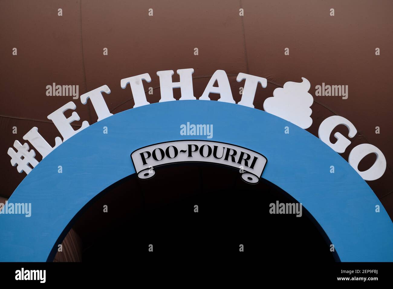 Company signage is pictured over the exit of a giant poo emoji set up ...