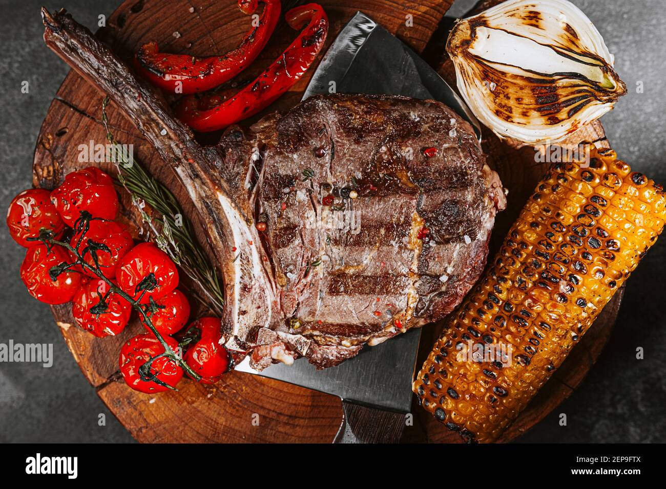 fresh grilled tomahawk steak with vegetables Stock Photo - Alamy