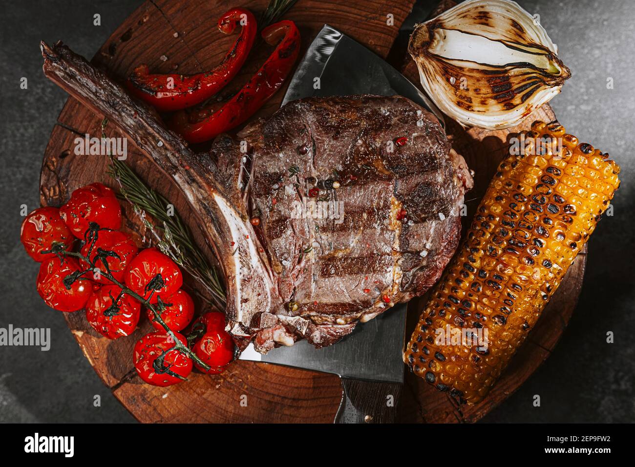 fresh grilled tomahawk steak with vegetables Stock Photo - Alamy
