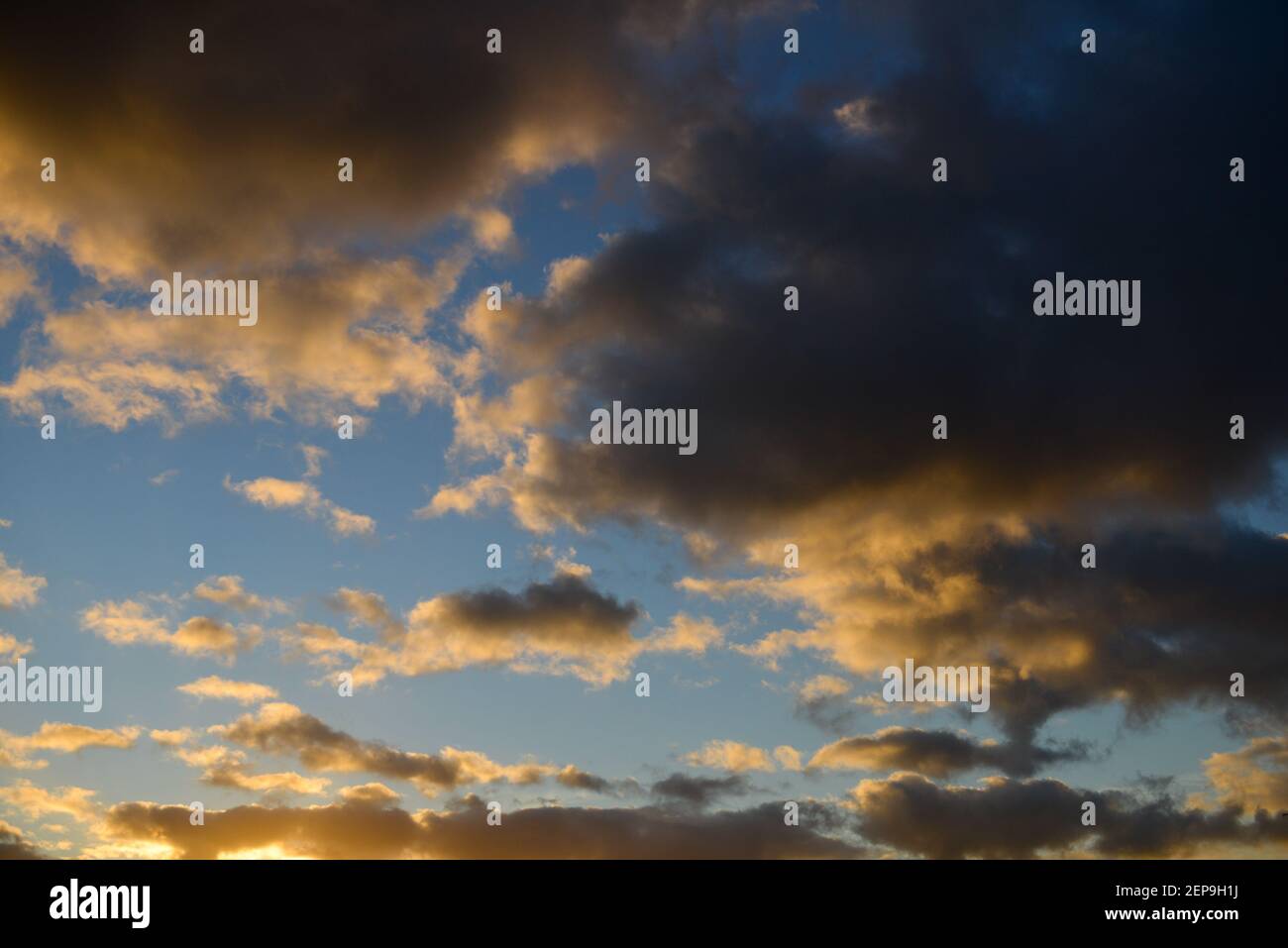Background dramatic sky texture with yellow and dark clouds at sunset ...