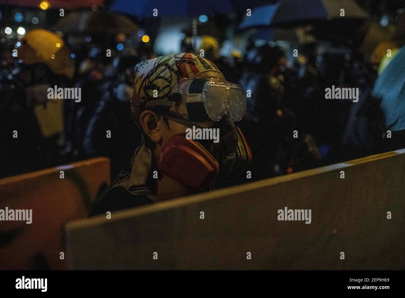 Protester using respirator mask protects himself with an improvised ...