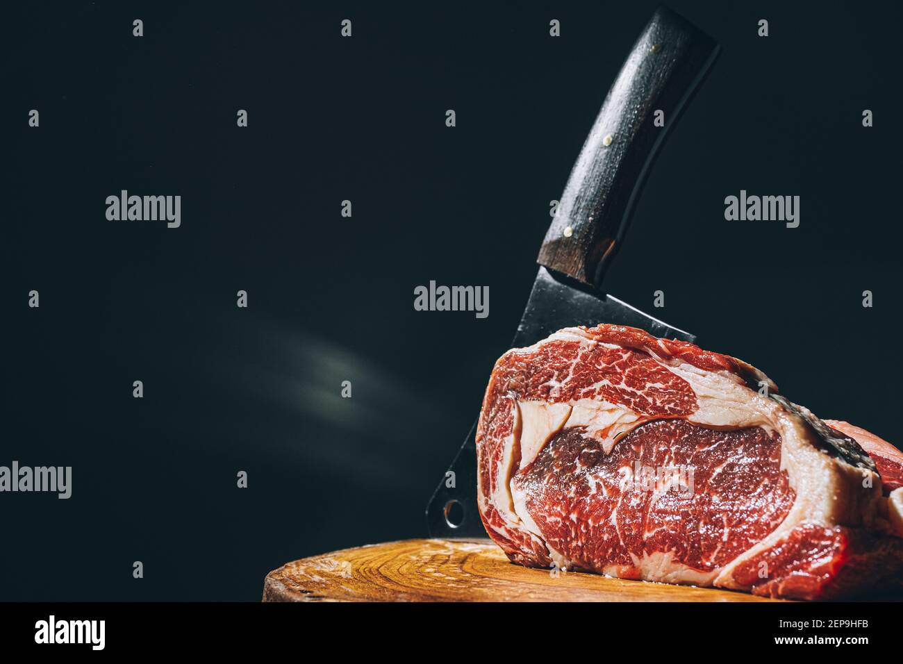 butcher knife and meat on a cutting board Stock Photo - Alamy