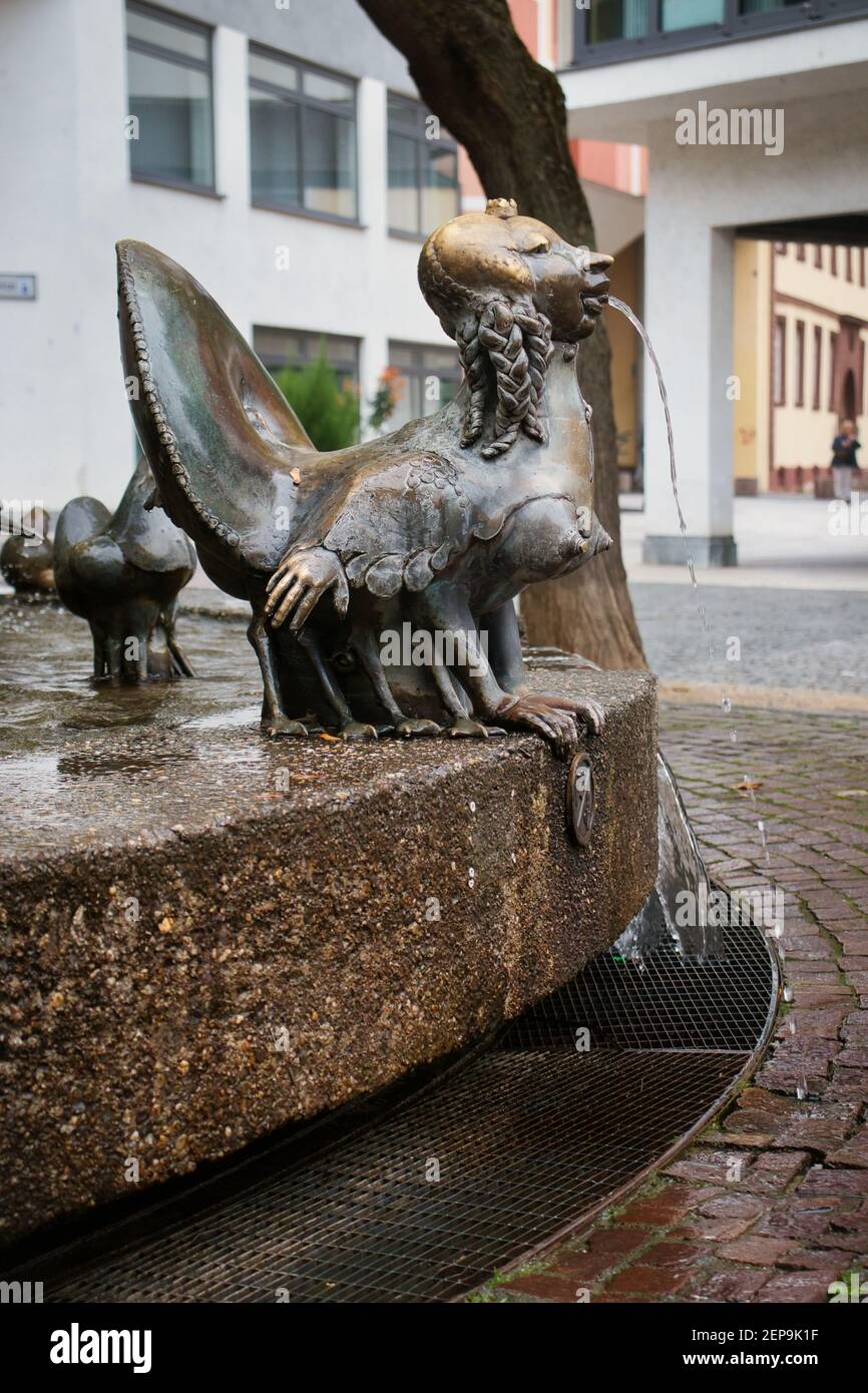 Mythical birlike creatures with human features in a fountain ...