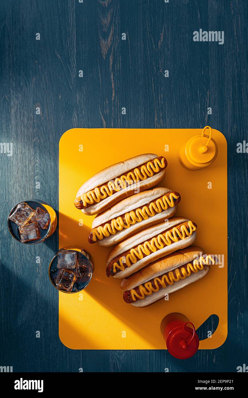 four fresh ready to eat american hot dogs Stock Photo - Alamy