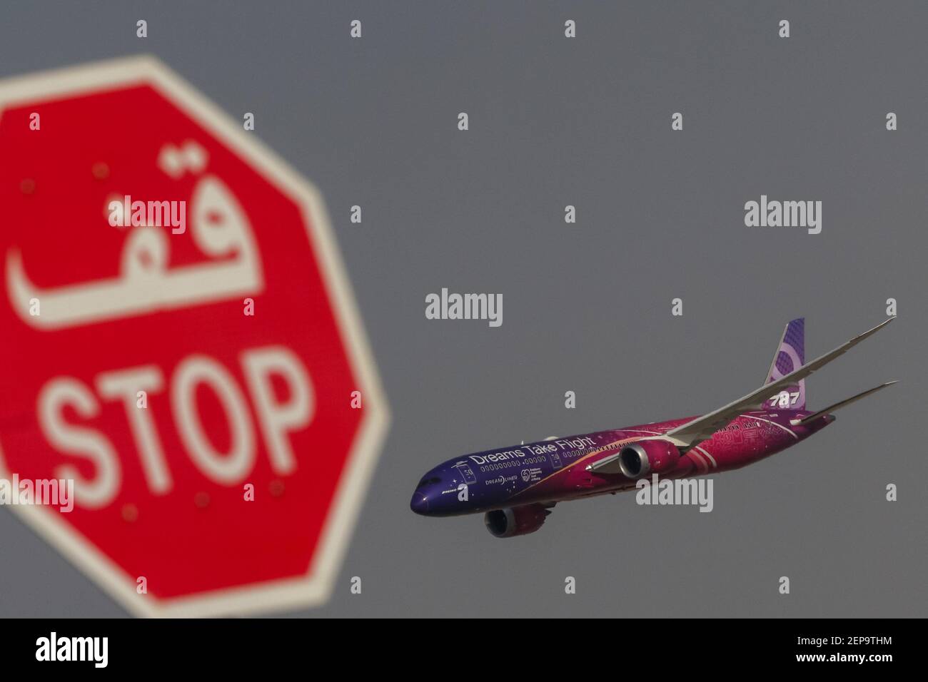 The Boeing 787-9 civil jetliner flies behind a STOP sign while ...
