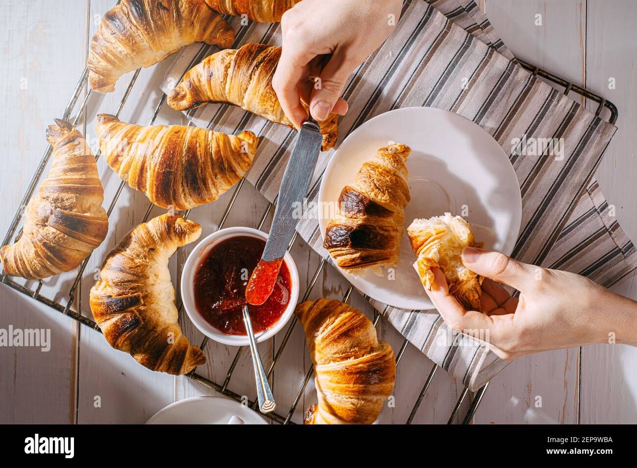 female hands on croissant spread jam Stock Photo - Alamy