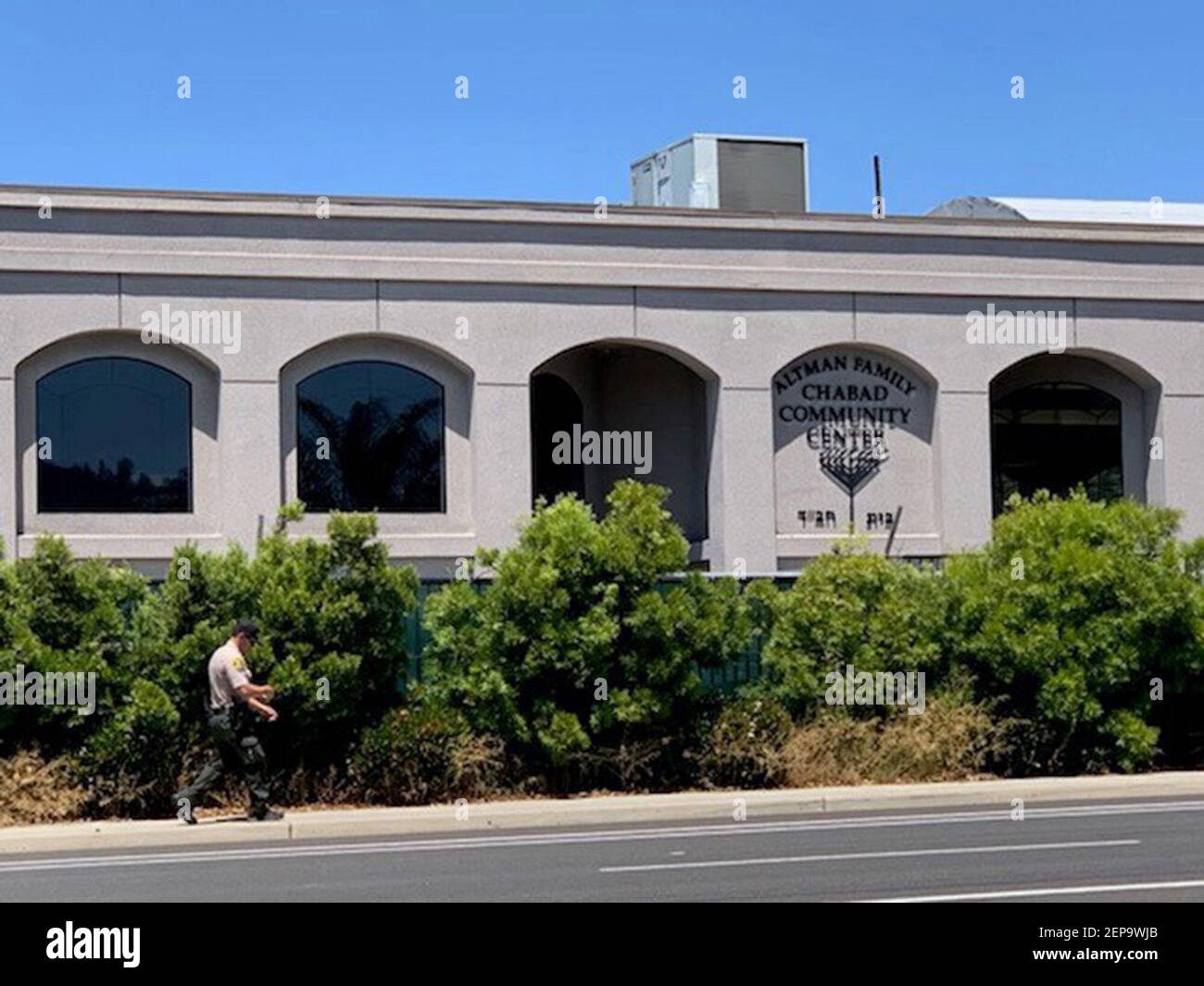 A sheriff's deputy walks by the Congregation Chabad of Poway, where as ...