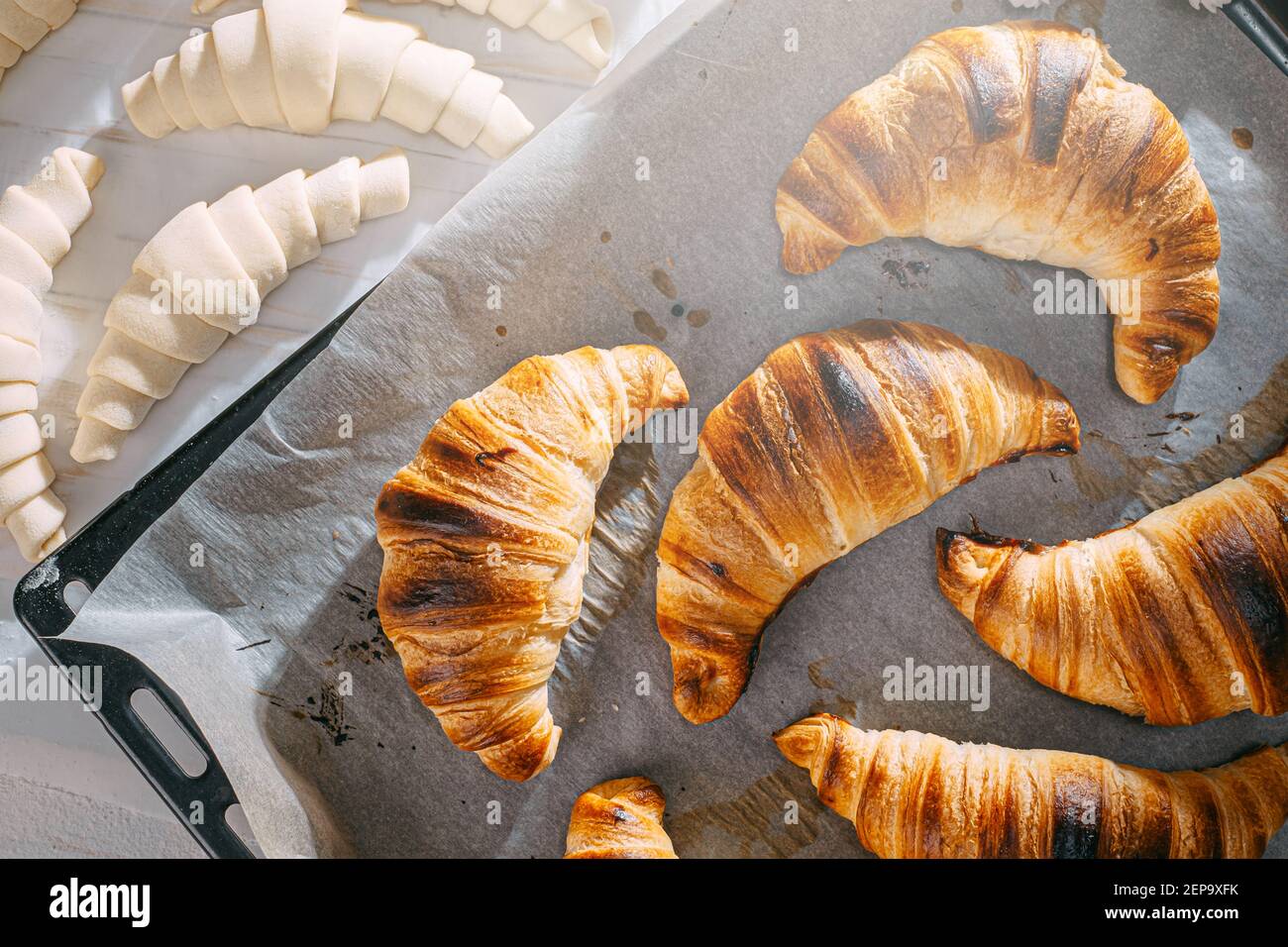 the chef cooks croissants in the kitchen in the morning, on the table ...