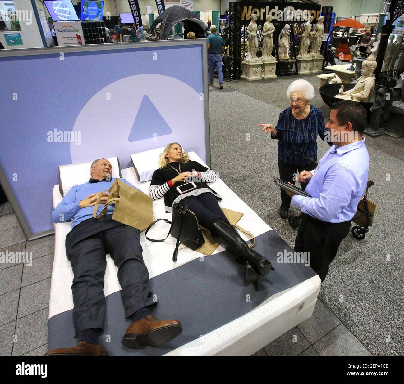 Visitors check out a bed at the Sleep Number exhibit at the 11th Annual ...