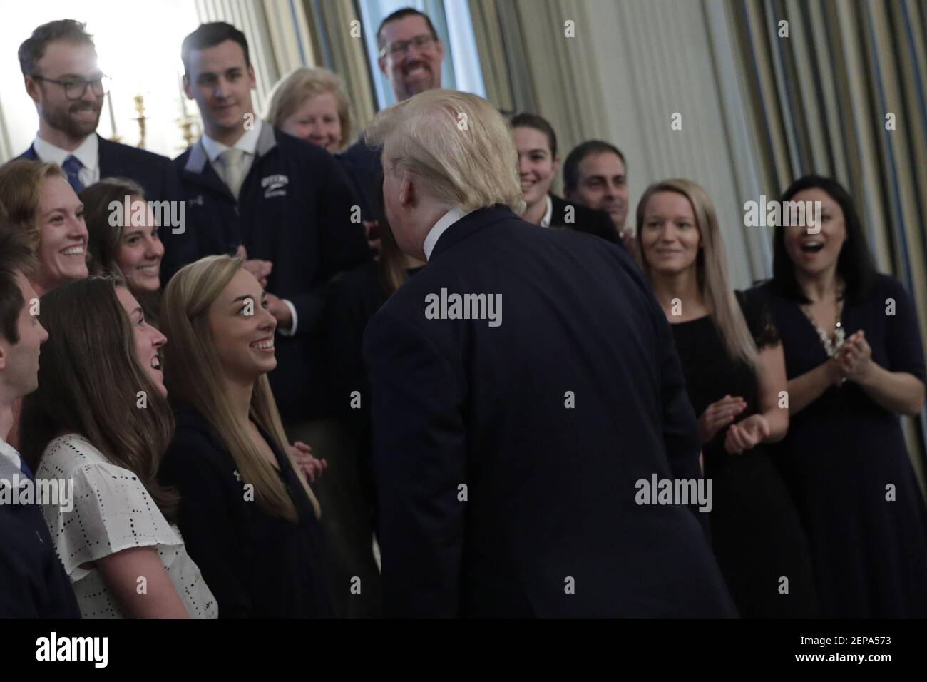 U.S. President Donald Trump greets athletes from the Queens University ...