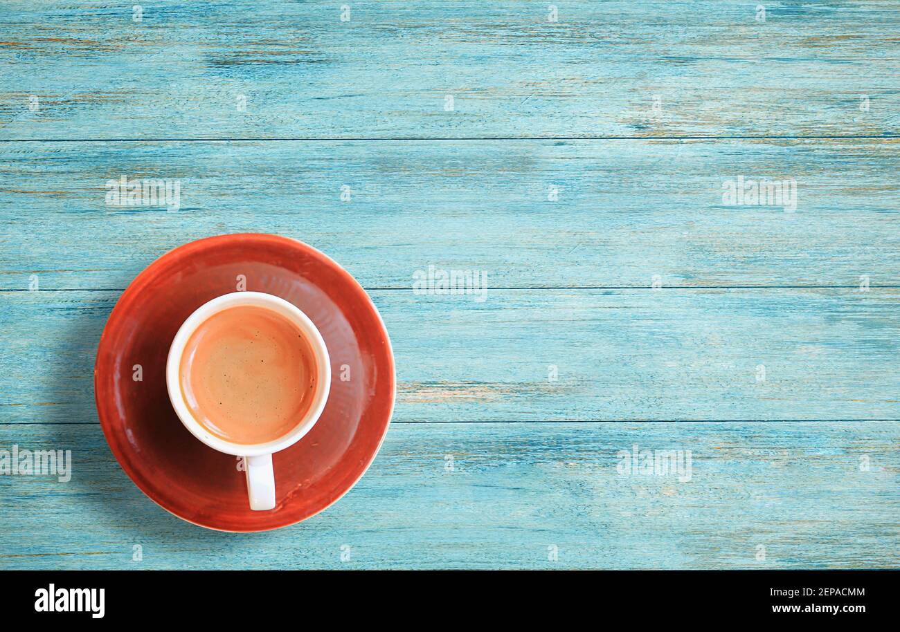 Cup of coffee on a wood table background. Top view with copy space ...