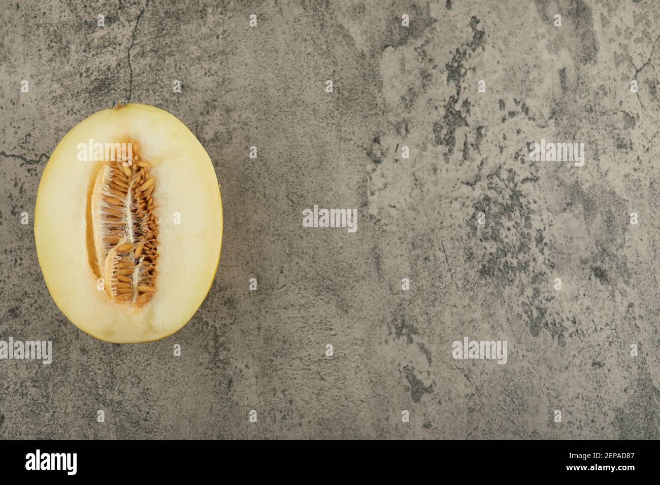 Half sliced yellow sweet melon on marble surface Stock Photo - Alamy