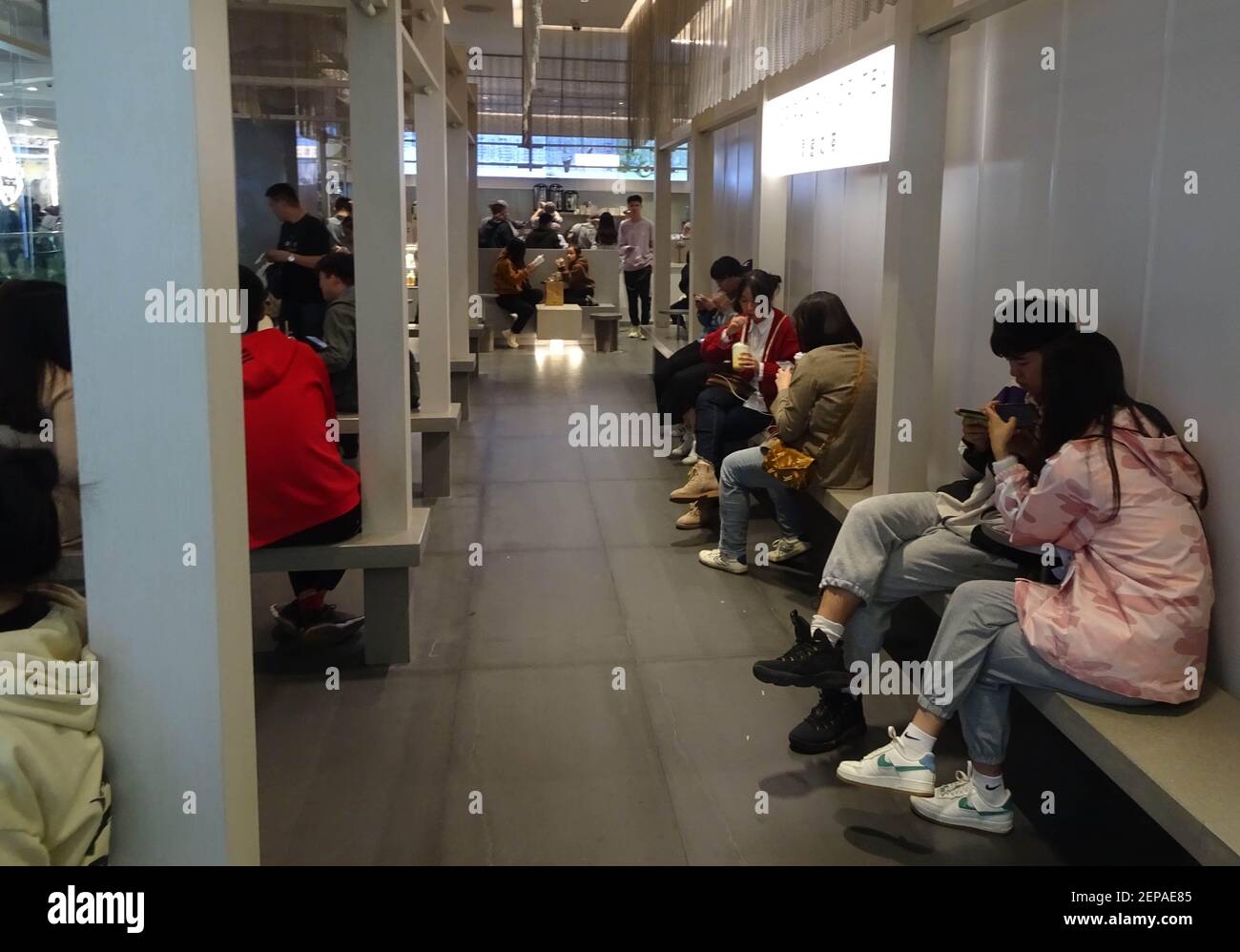 Customers wait for milk tea they ordered from the newly opened HEYTEA, one of most popular tea ...