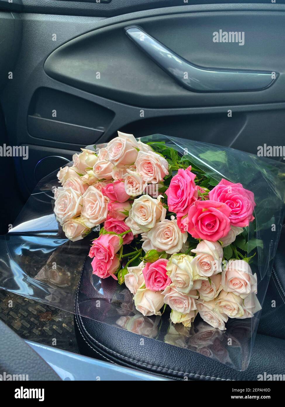 A bouquet of roses flowers for lady in the front seat of the car Stock ...