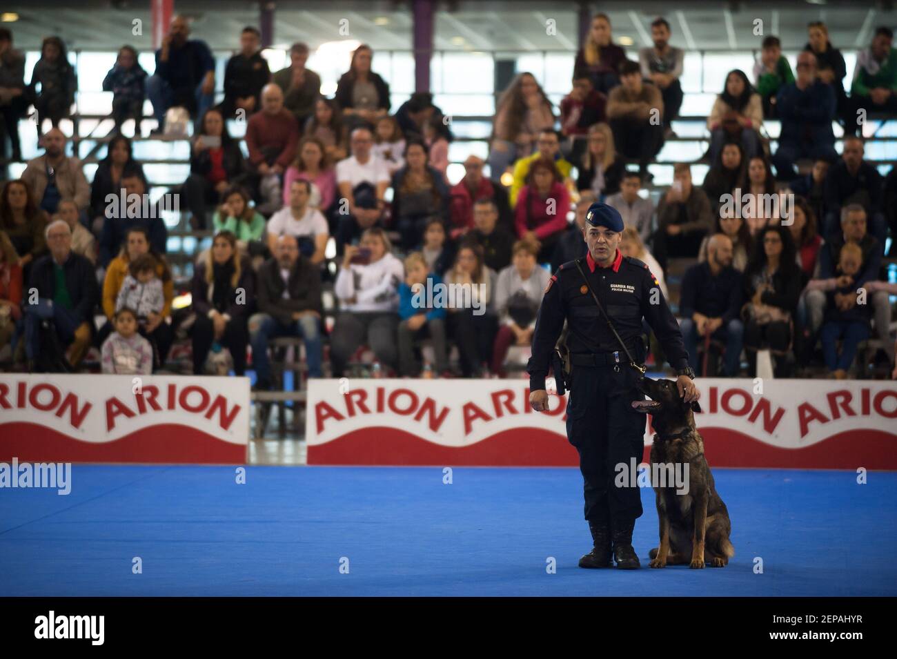 A member of royal guard stand on the stage with his dog during the fair ...