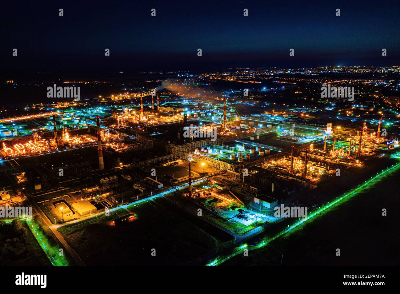 Aerial view oil and gas oil refinery at night. Pipes and large tanks ...