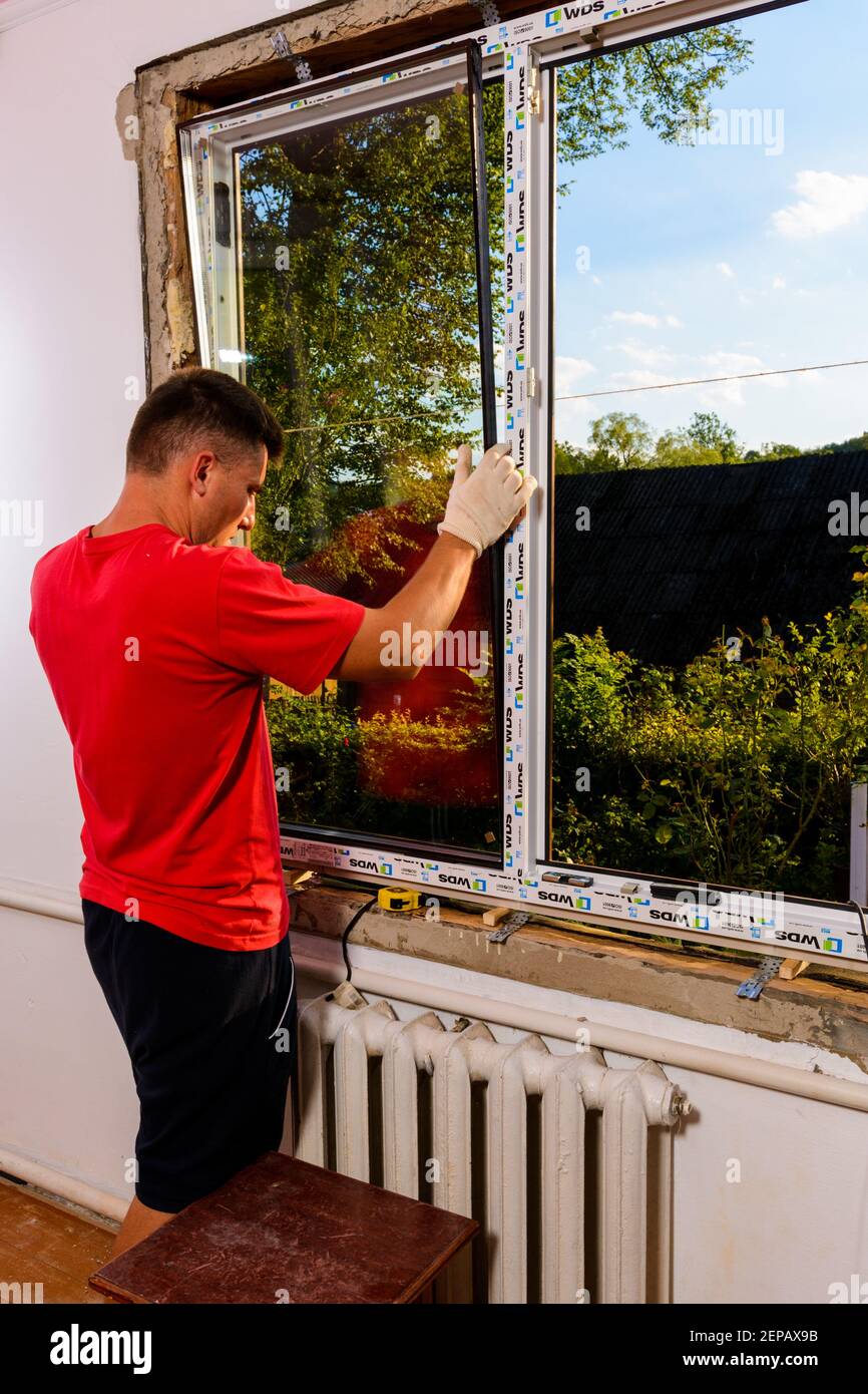 Dolyna, Ukraine July 31, 2020: an employee installs a window in the ...