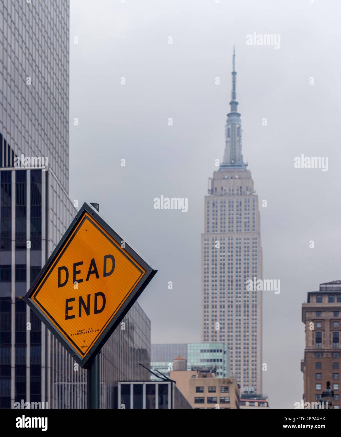street scene in New York with Dead End sign and Empire State Building ...