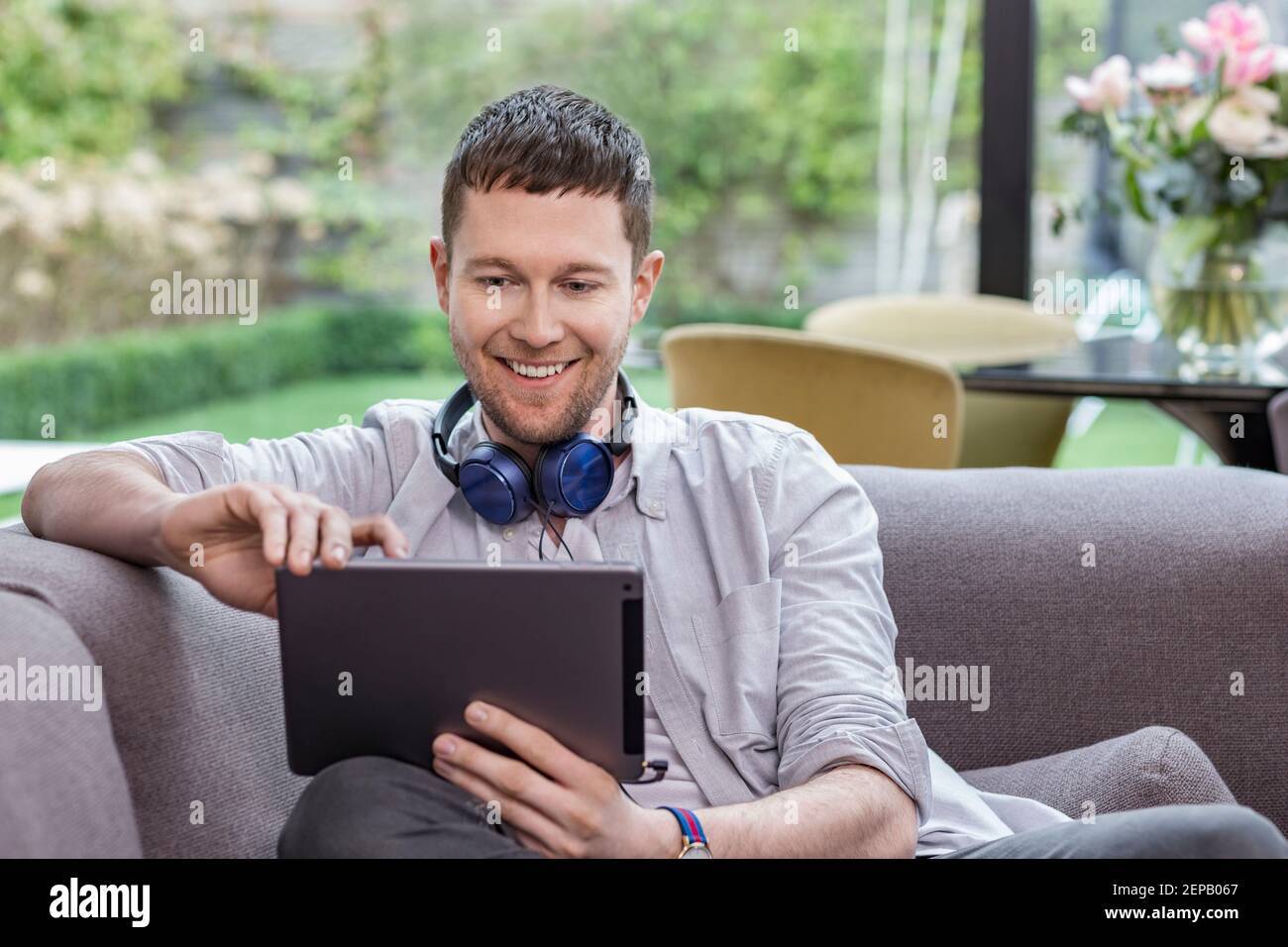 Family relaxing on sofa with iPad Stock Photo - Alamy