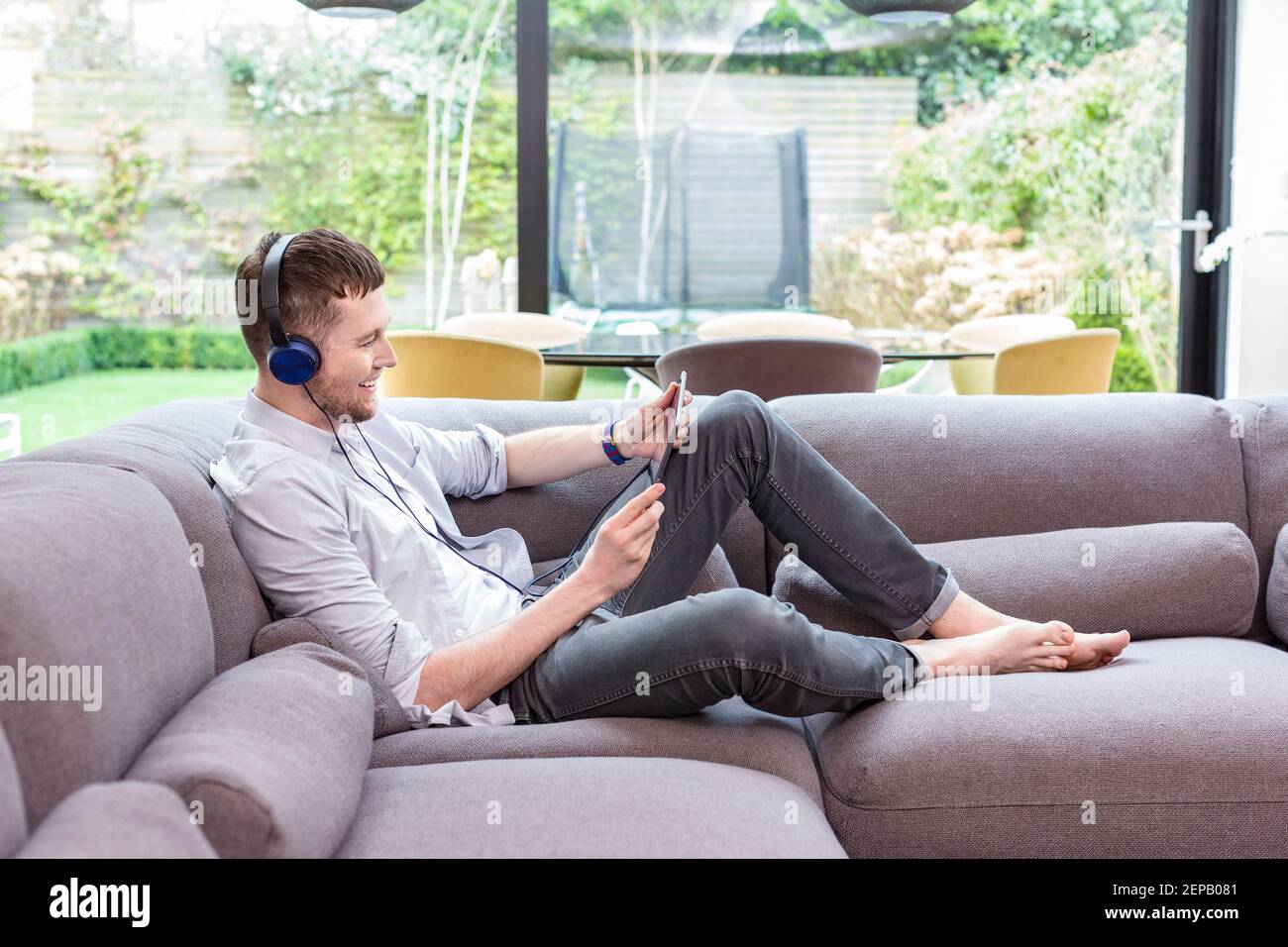 Family relaxing on sofa with iPad Stock Photo - Alamy