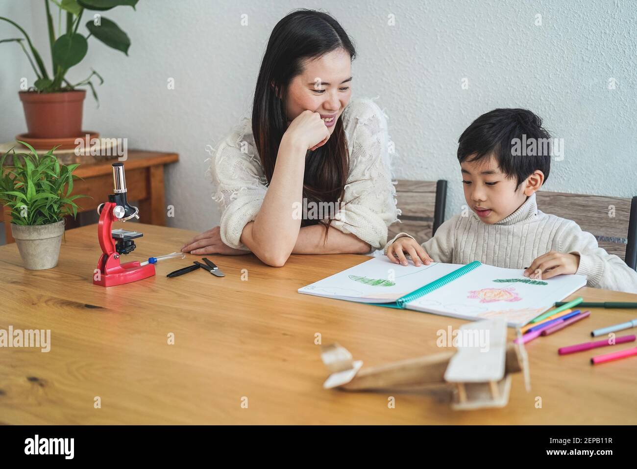 Asian teacher working with child boy at preschool - Focus on woman face ...