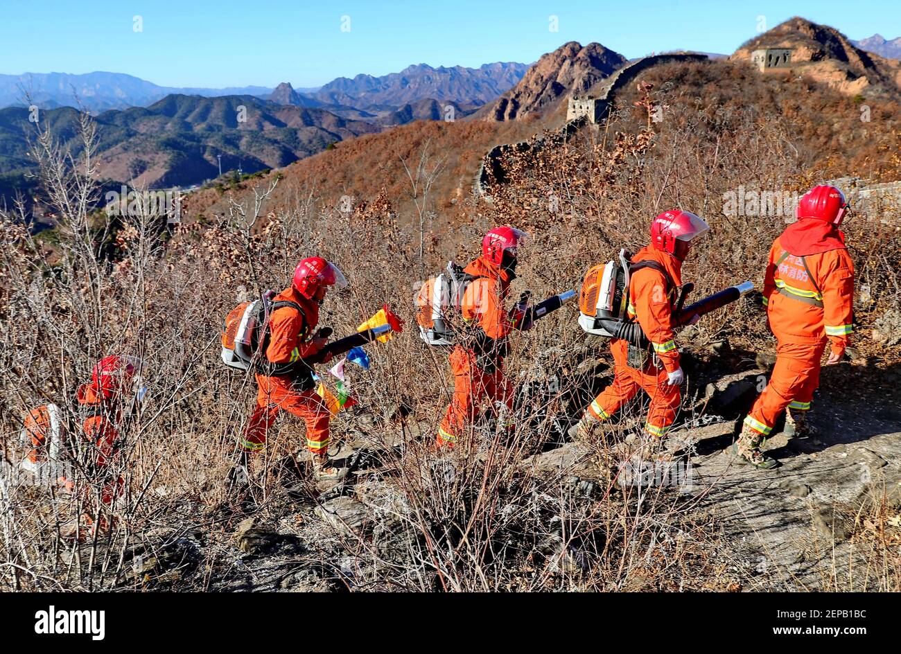 Chinese firefighters from the local forest firefighting brigade patrol ...