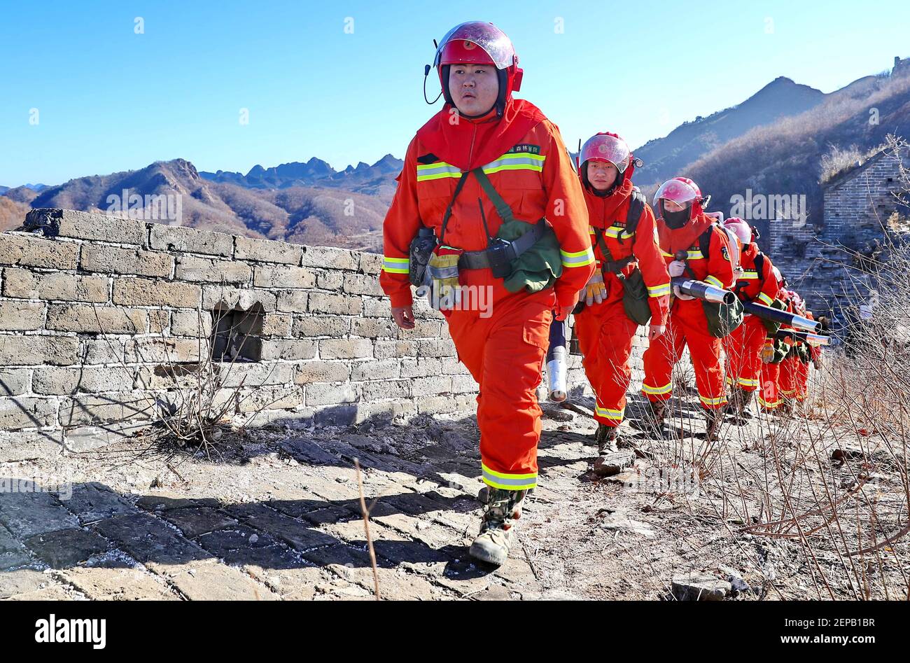 Chinese firefighters from the local forest firefighting brigade patrol ...