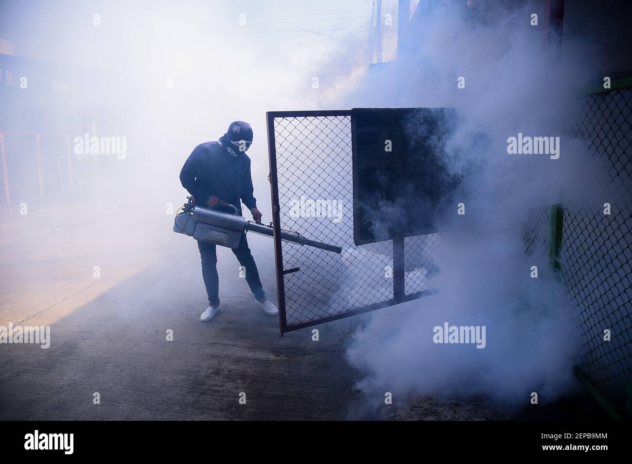 Man spray fogging to eliminate mosquitoes that cause dengue hemorrhagic ...