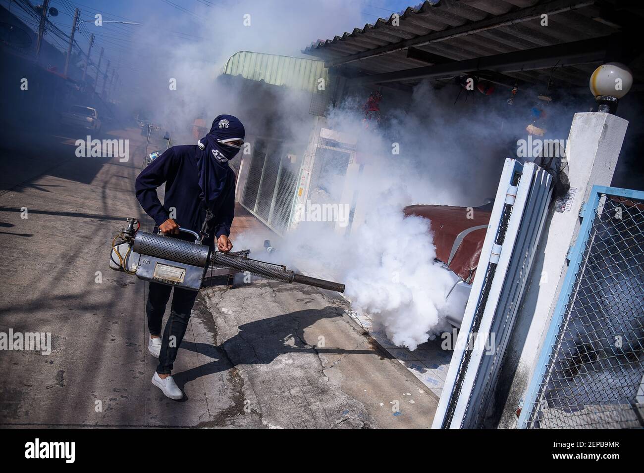 Man spray fogging to eliminate mosquitoes that cause dengue hemorrhagic ...