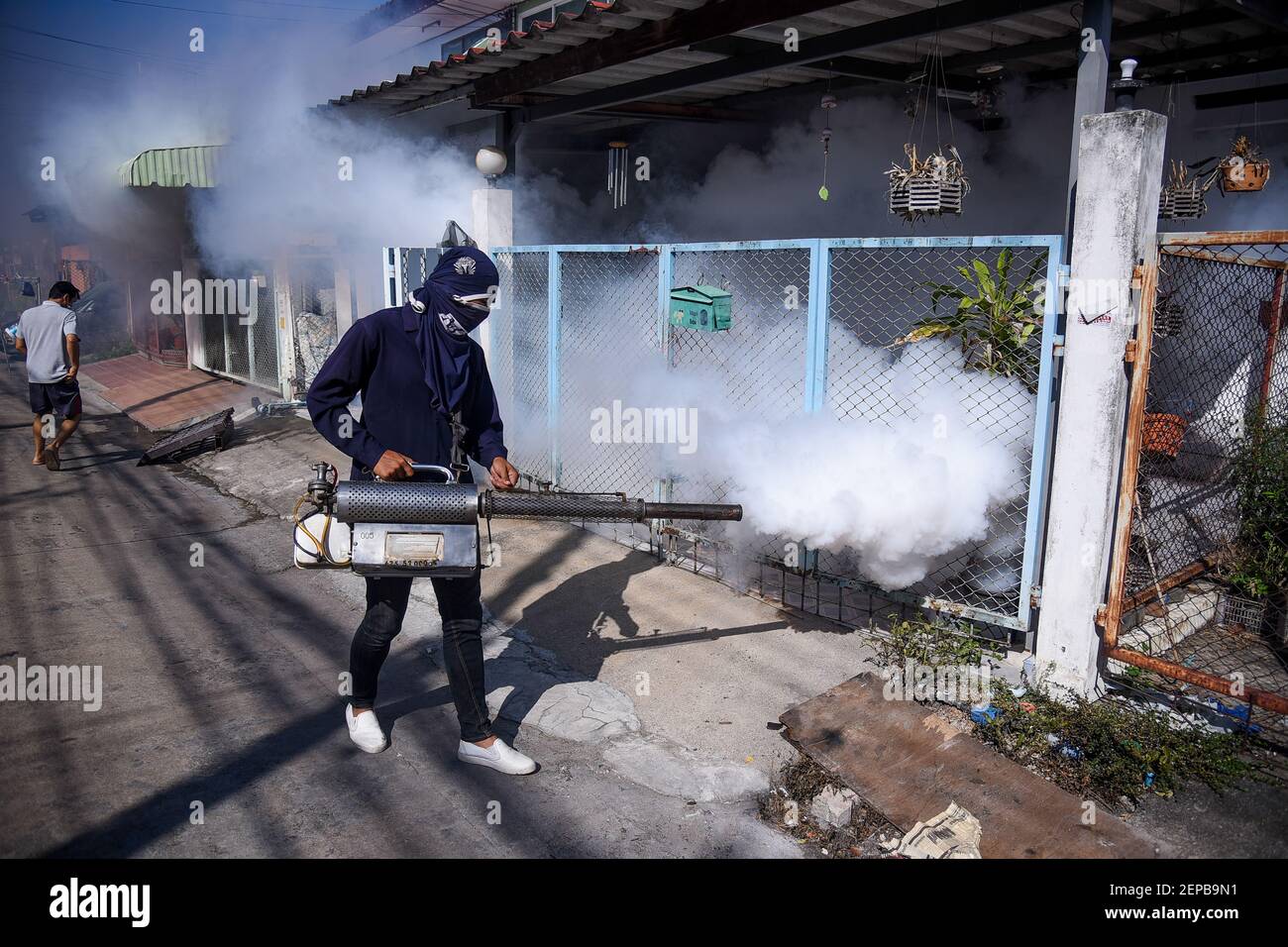 Man spray fogging to eliminate mosquitoes that cause dengue hemorrhagic ...