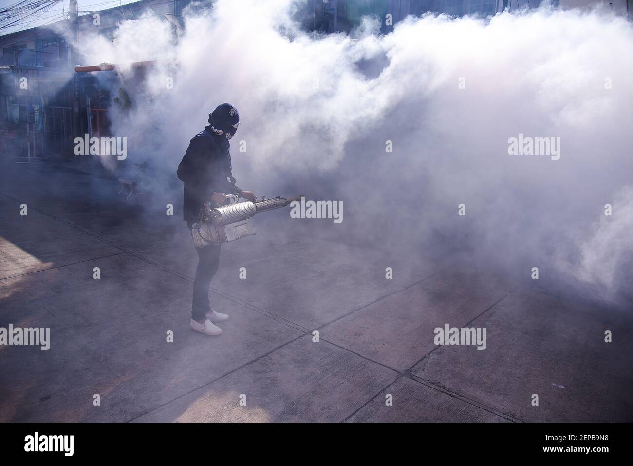 Man spray fogging to eliminate mosquitoes that cause dengue hemorrhagic ...