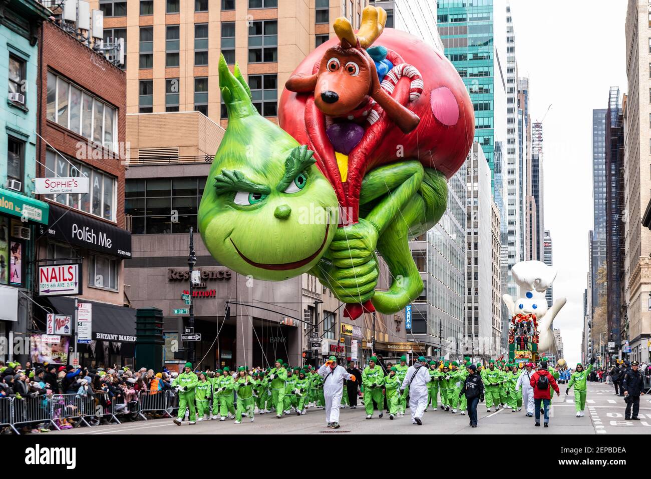 The Grinch balloon floats along 6th Avenue as thousands of spectators ...