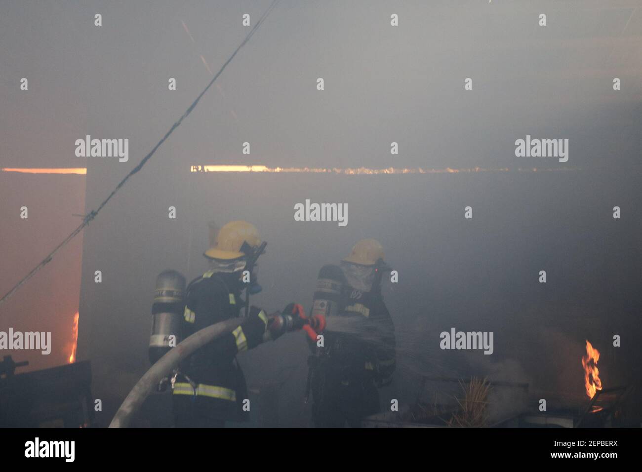 Firemen work to put a fire at a warehouse in Yulin city, south China's ...