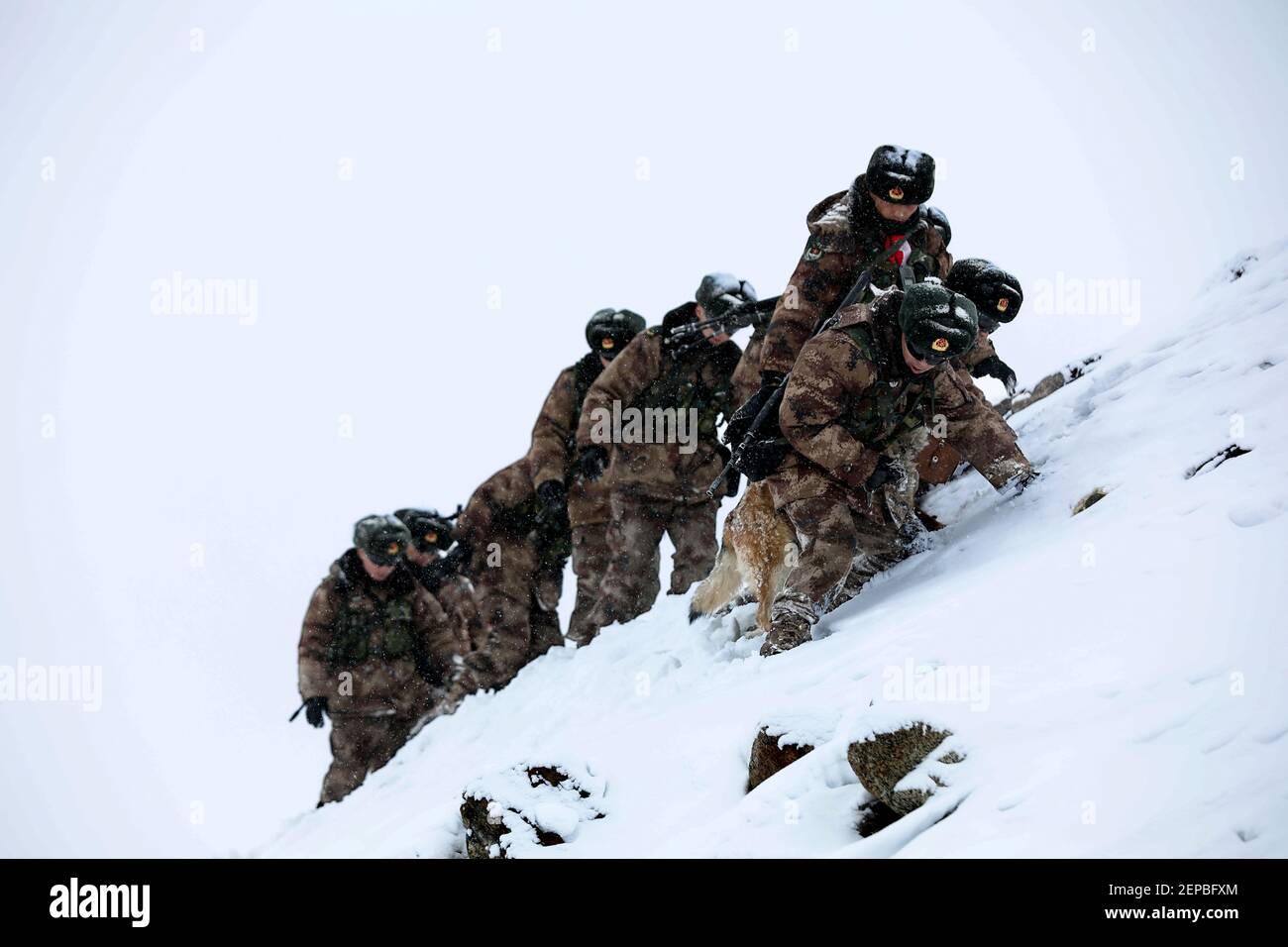 Chinese PLA (People's Liberation Army) soldiers patrol the snow ...