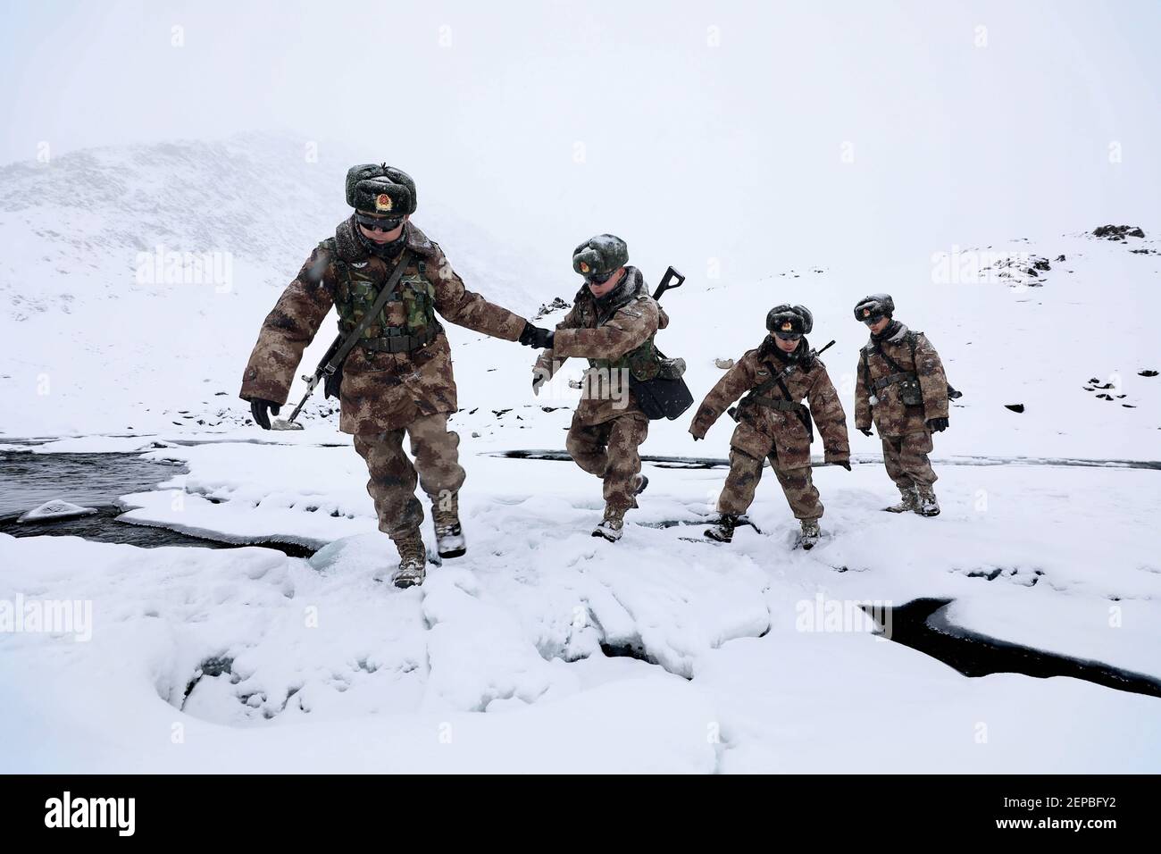 Chinese PLA (People's Liberation Army) soldiers patrol the snow ...