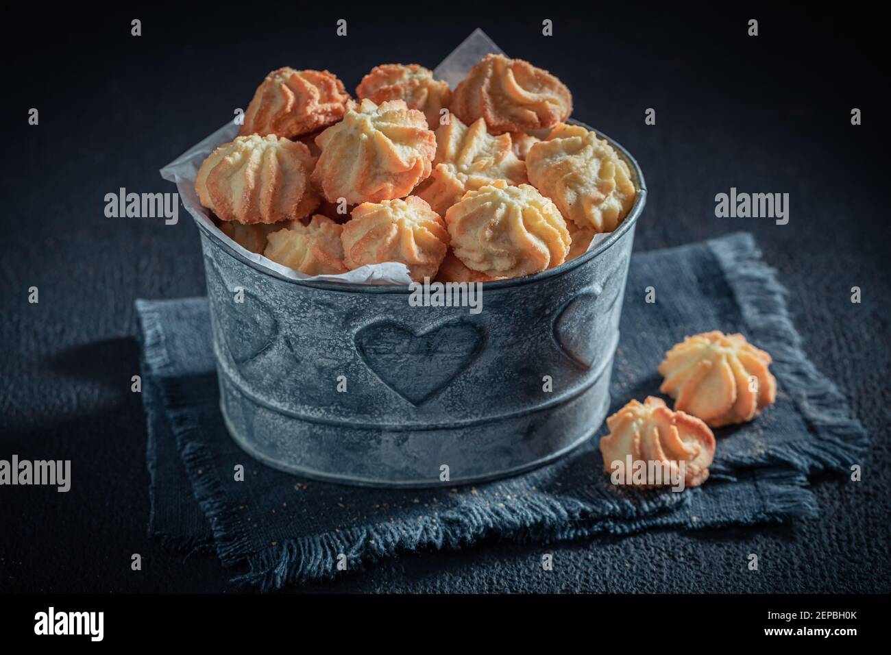 Delicious butter cookies served in old metal bucket on dark table Stock ...