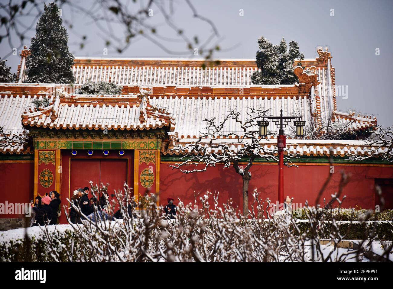 People walk past ancient Chinese constructions covered with snow at ...