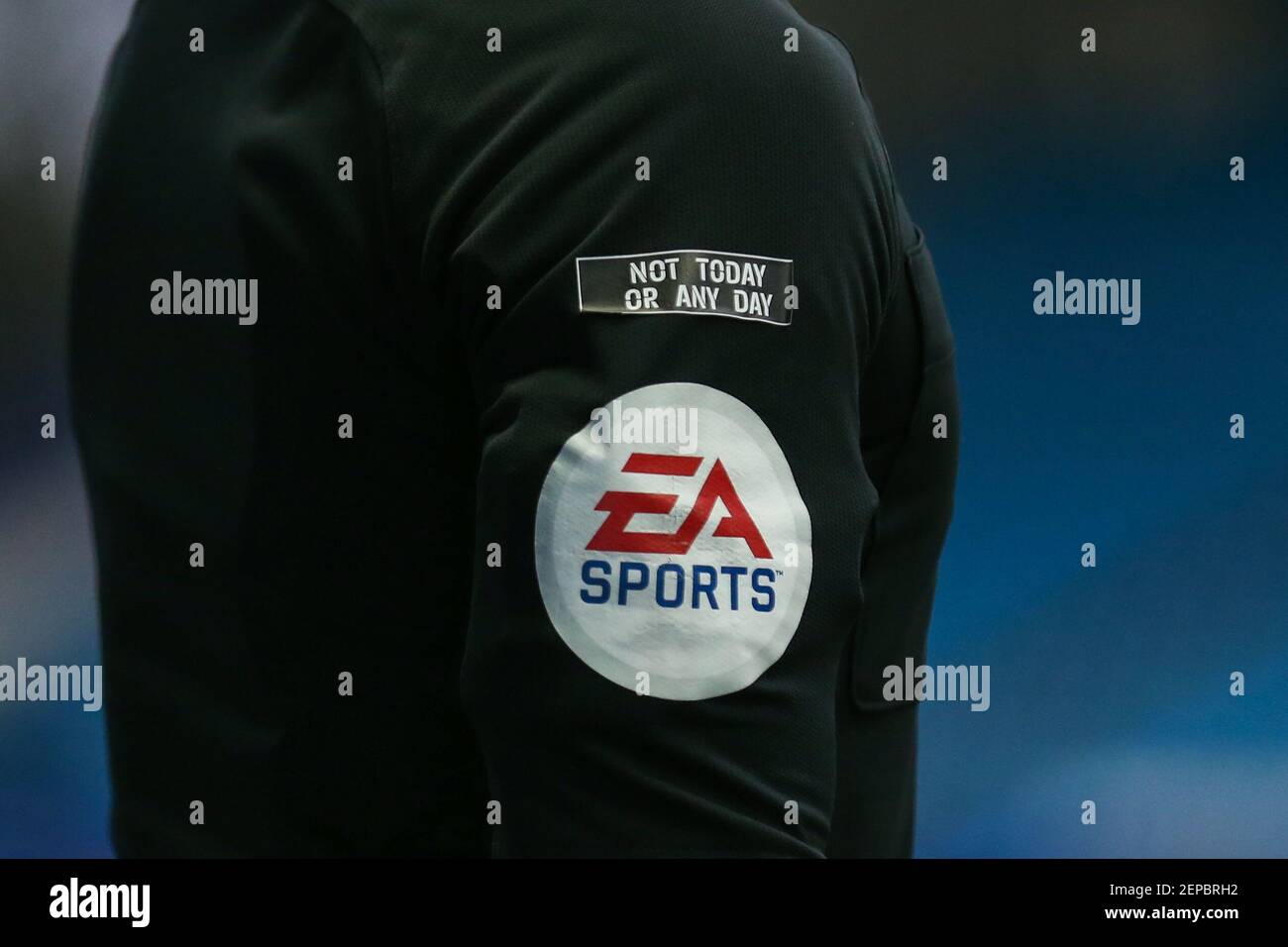 A detailed view of an anti-racism badge on the arm of assistant referee ...