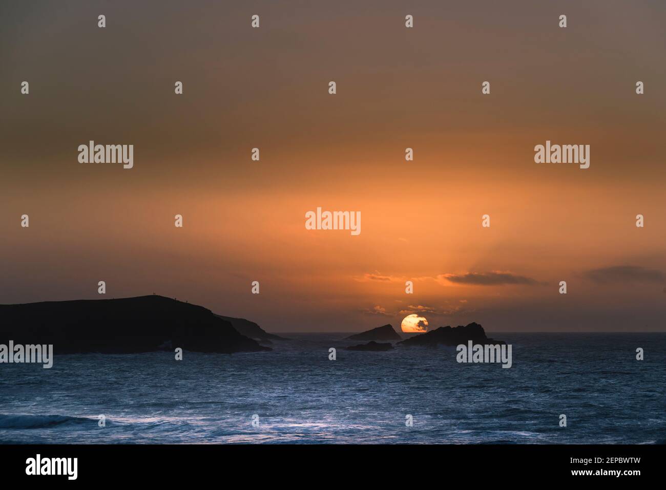 An intense spectacular sunset over Fistral Bay in Newquay in Cornwall ...