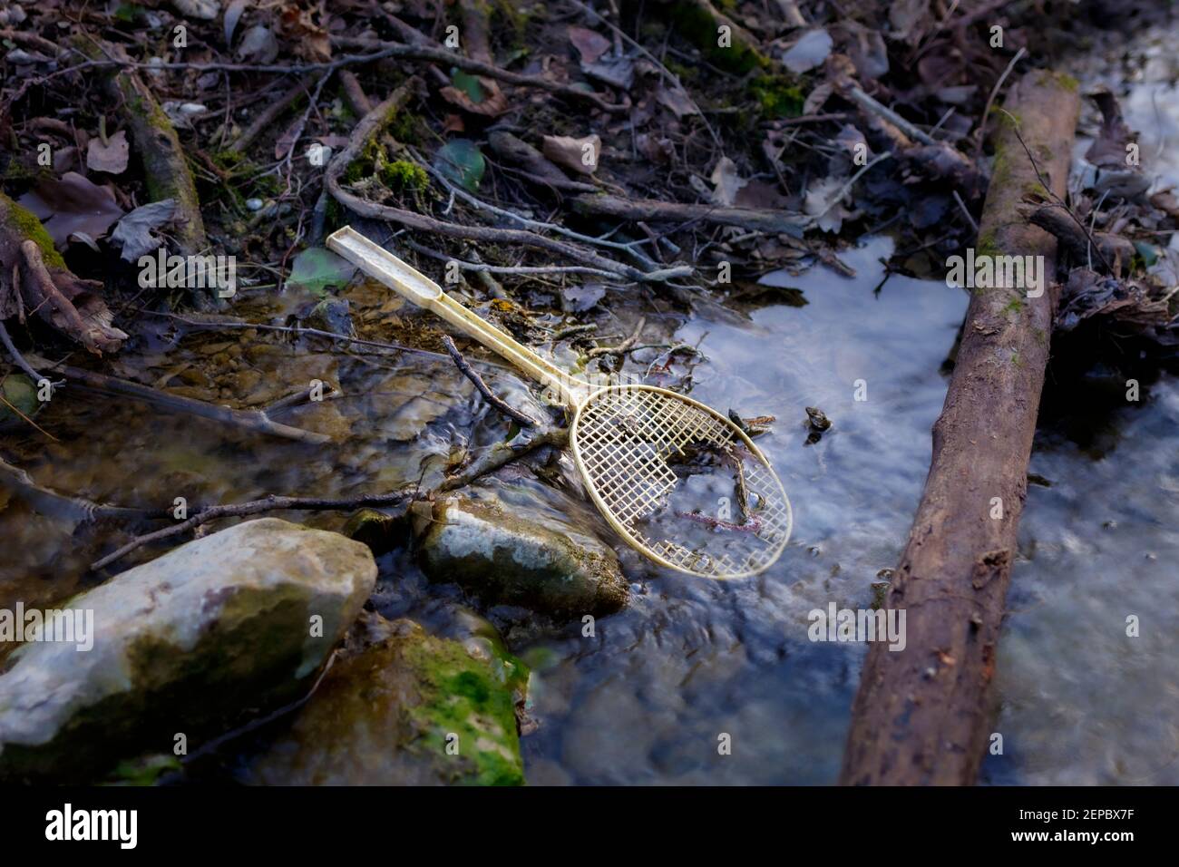 Small plastic racket abandoned Stock Photo - Alamy