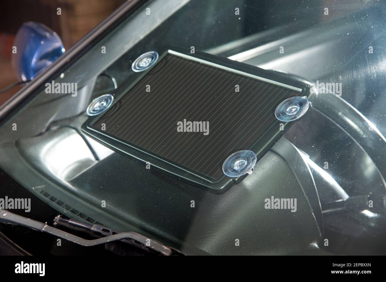 solar car battery charger in a car window Stock Photo - Alamy