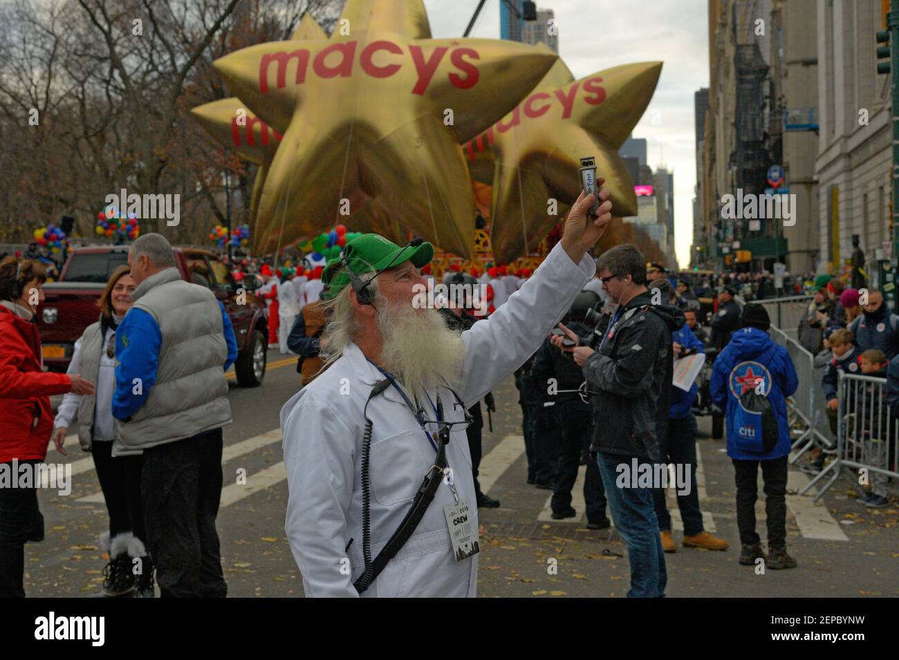 A balloon handler measure wind speed during the 93rd Annual Macy's ...